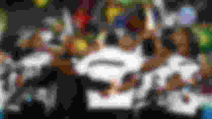 Fiji players and staff huddle as they win gold after the Men's Rugby ...