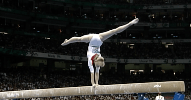 Team Romania performs their compulsory balance beam routines at Atlanta ...